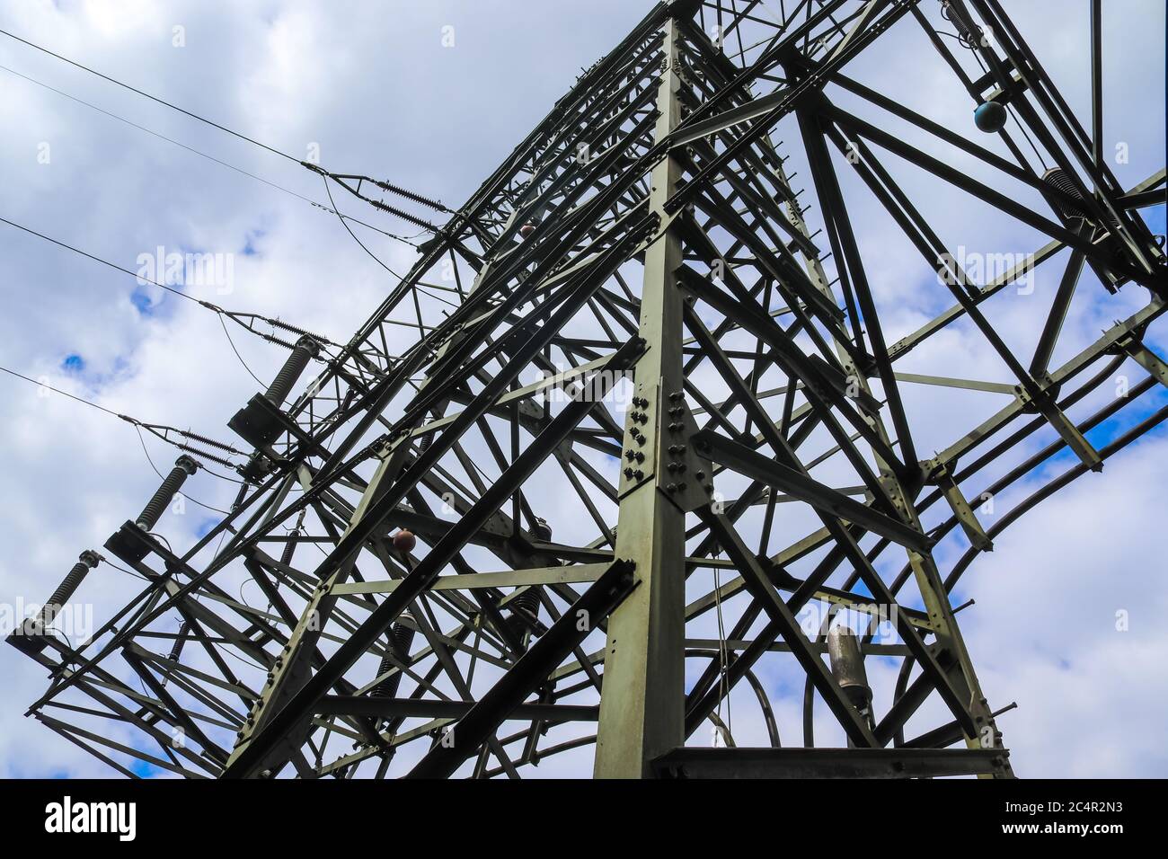 Close up view on a big power pylon transporting electricity in a ...