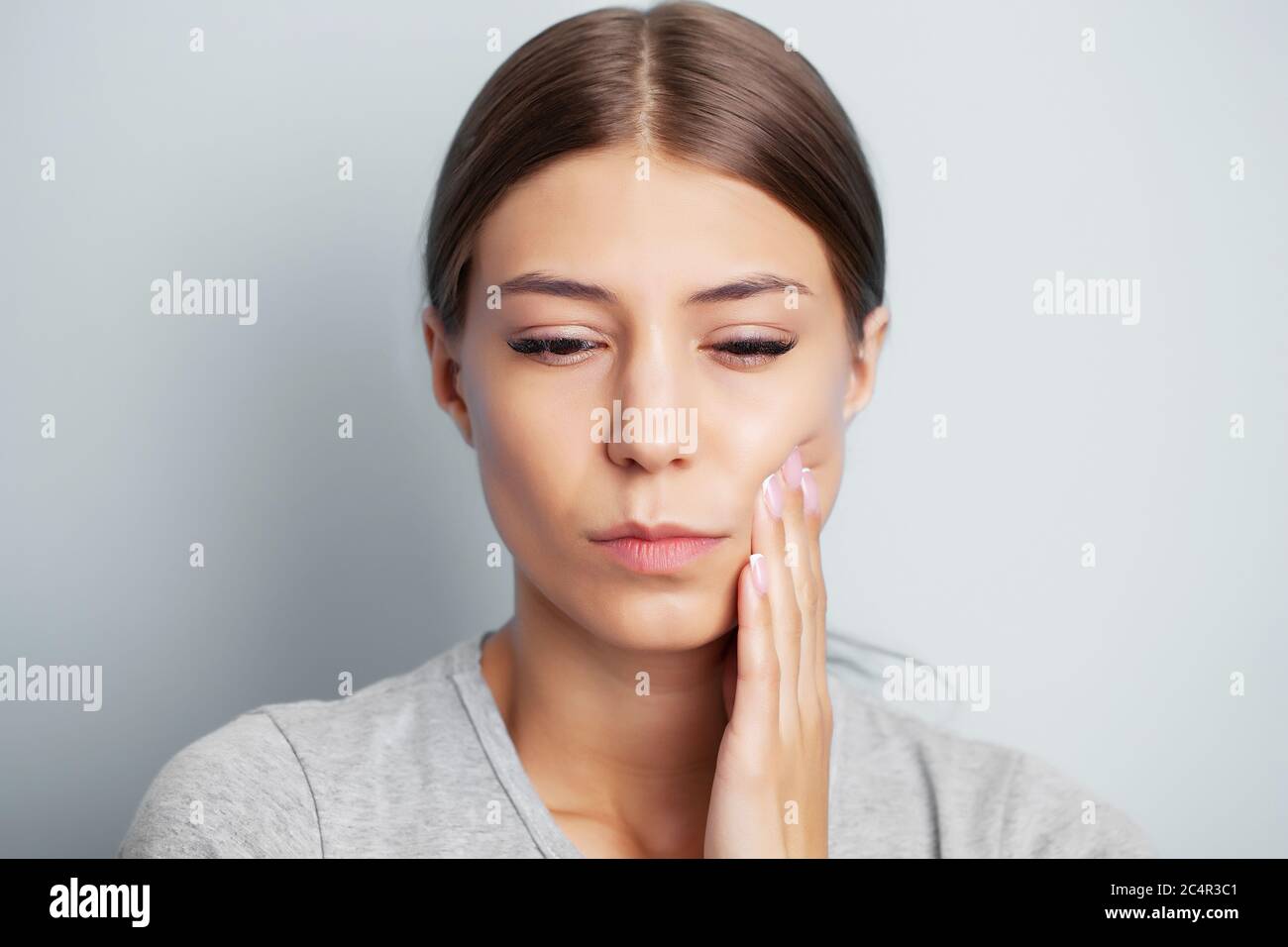 Exhausted young woman suffering from severe toothache Stock Photo - Alamy