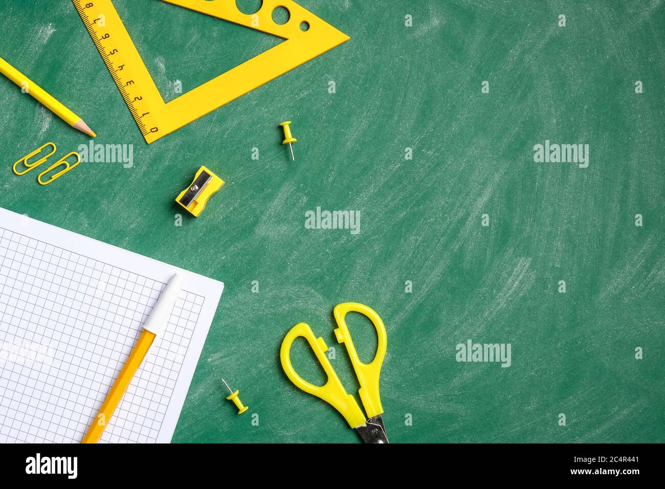 Back to school concept. Flat lay yellow school supplies and paper ...