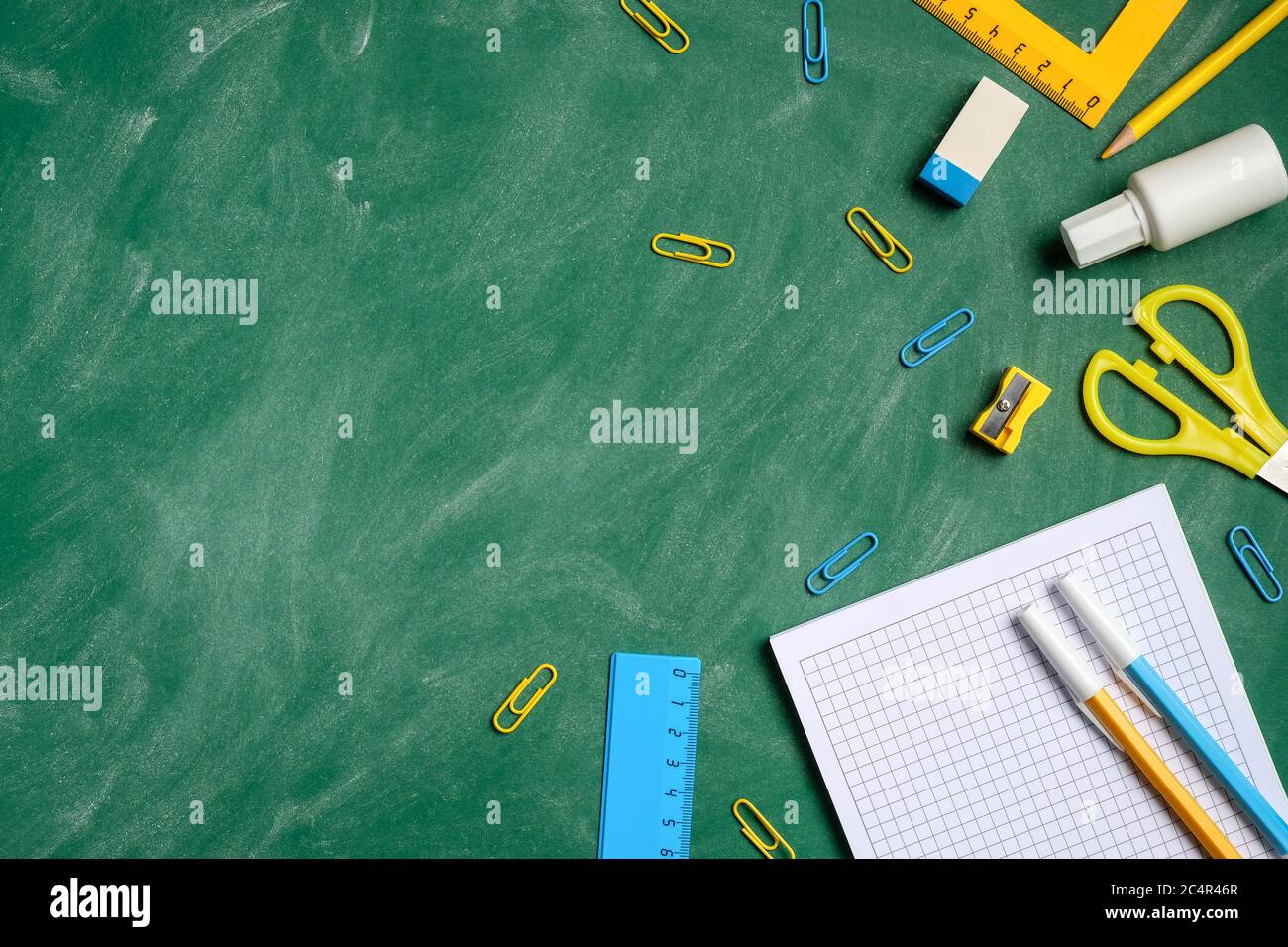 Back to school concept. Flat lay school supplies on green chalkboard ...