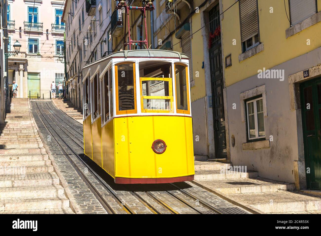 The Gloria Funicular in the city center of Lisbon in a beautiful summer ...