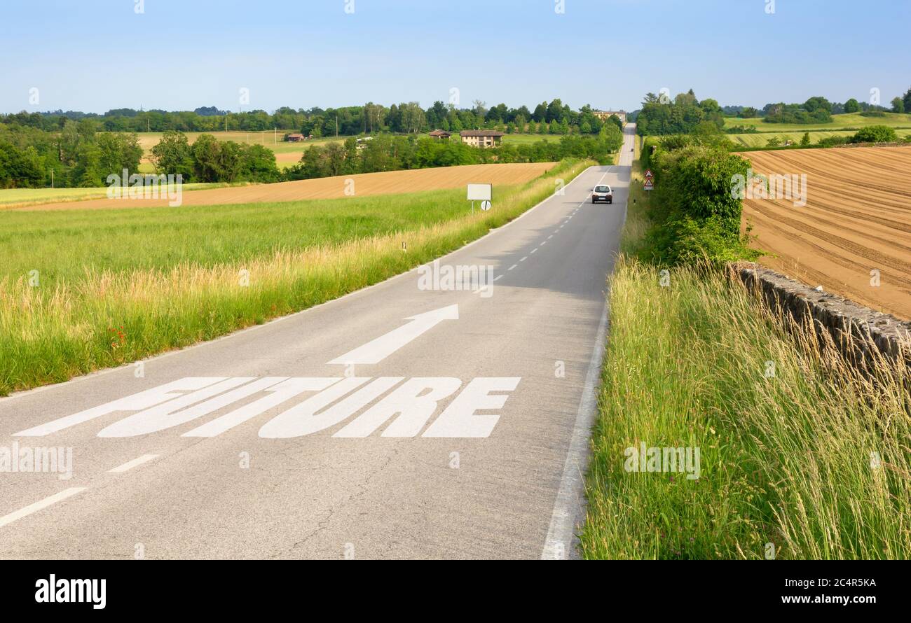 Country road among hills with sign on asphalt indicating the driving ...