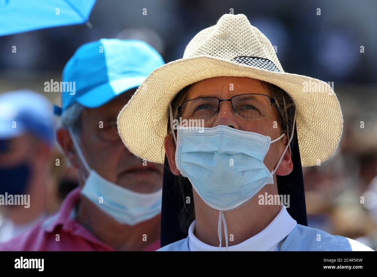 Vatican City, Vatican. 28th June, 2020. A nun wearing a mask looks at ...