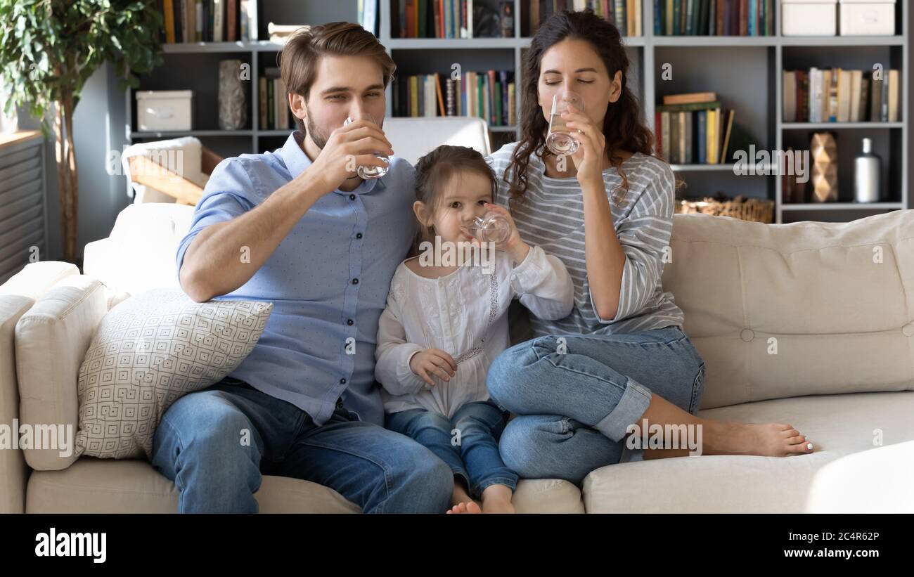 Happy healthy young family drinking pure mineral water together Stock ...