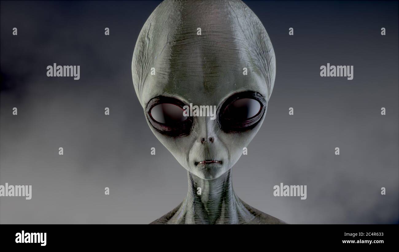Scary gray alien walks and looks blinking on a dark smoky background ...