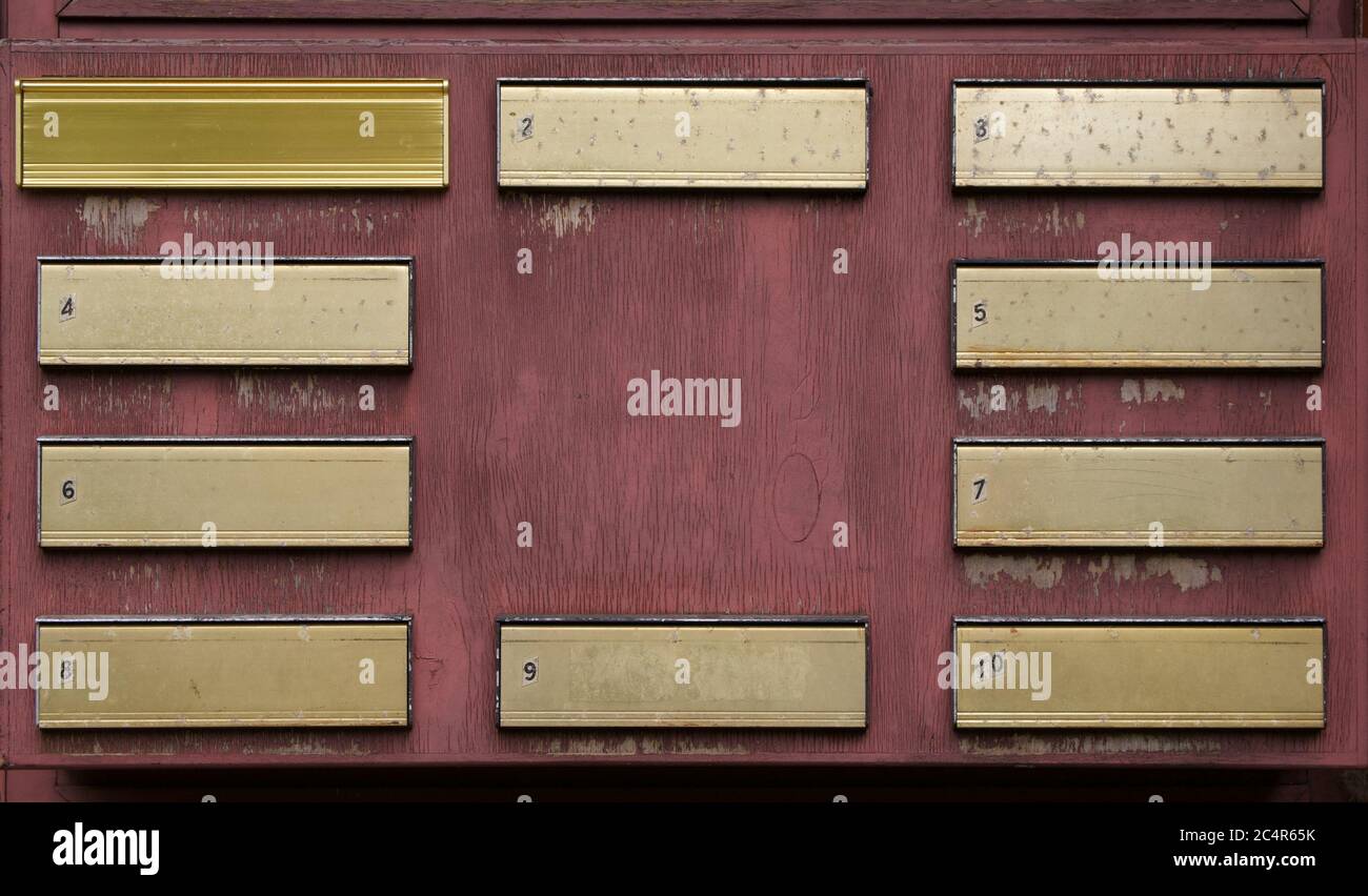 Numbered weathered metal letter boxes on wooden background with copy ...