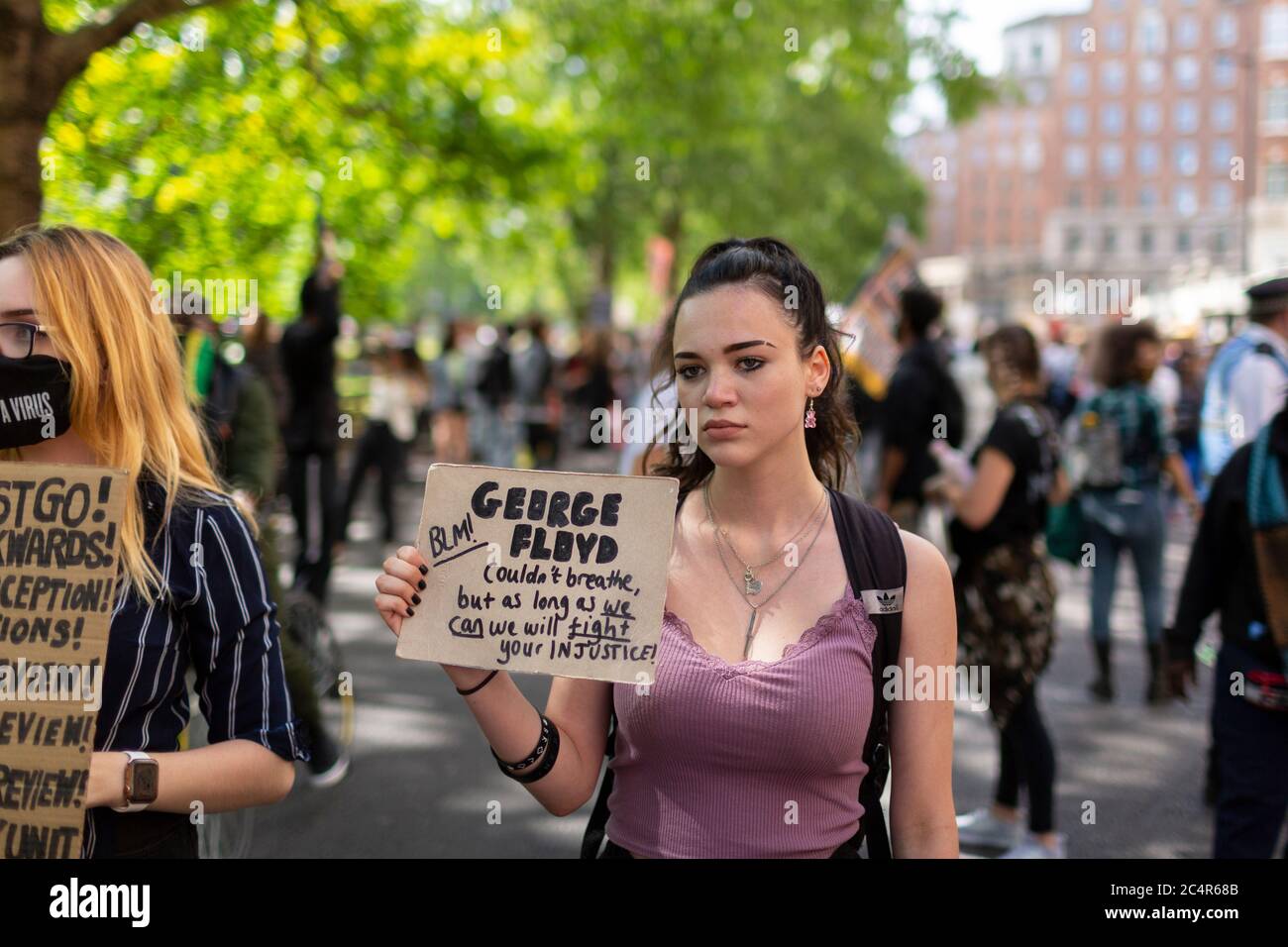 A female protester holds up a sign at a Black Lives Matter ...