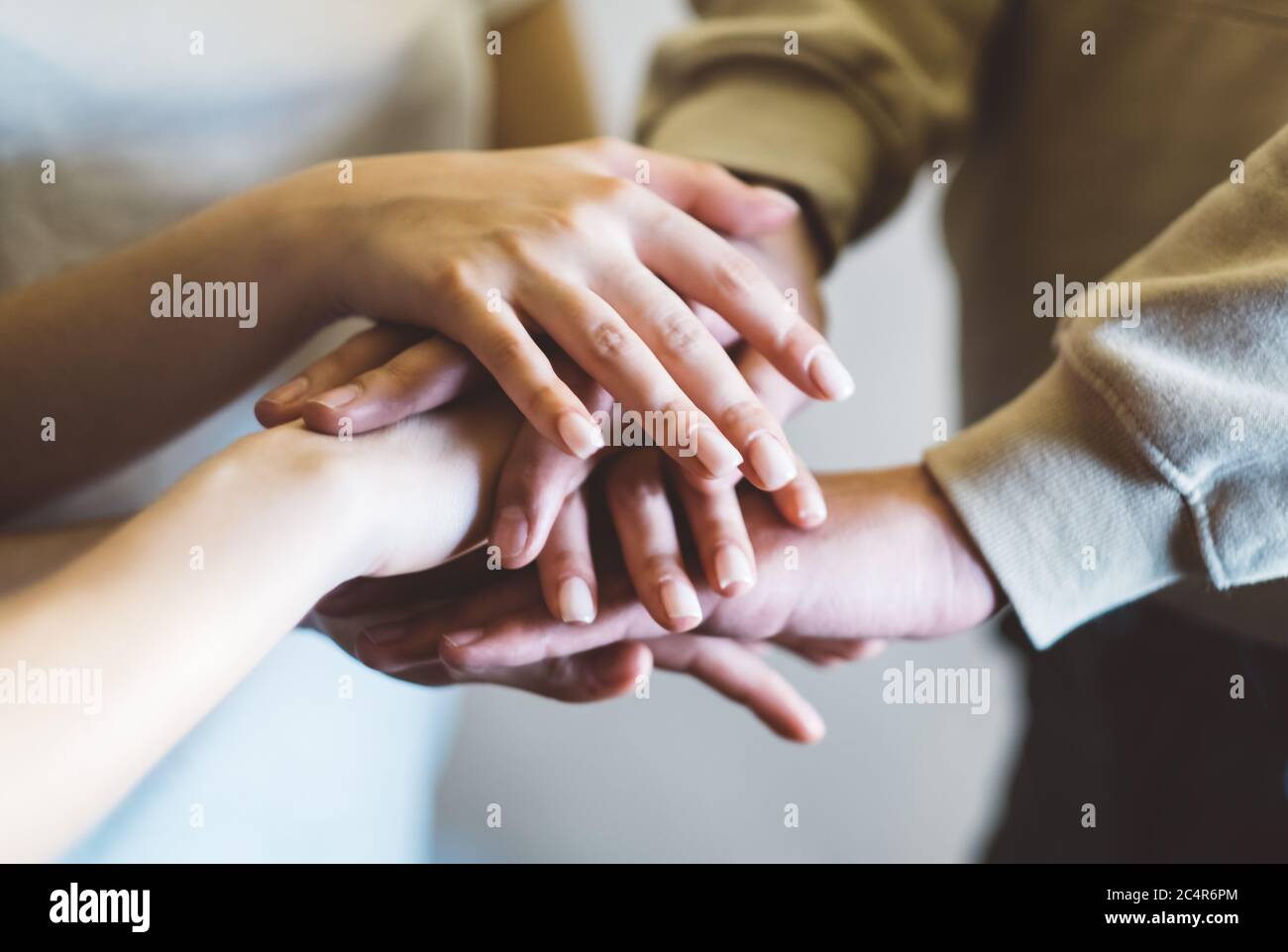 Group of young people puts their hands on each other, a symbol of unity ...