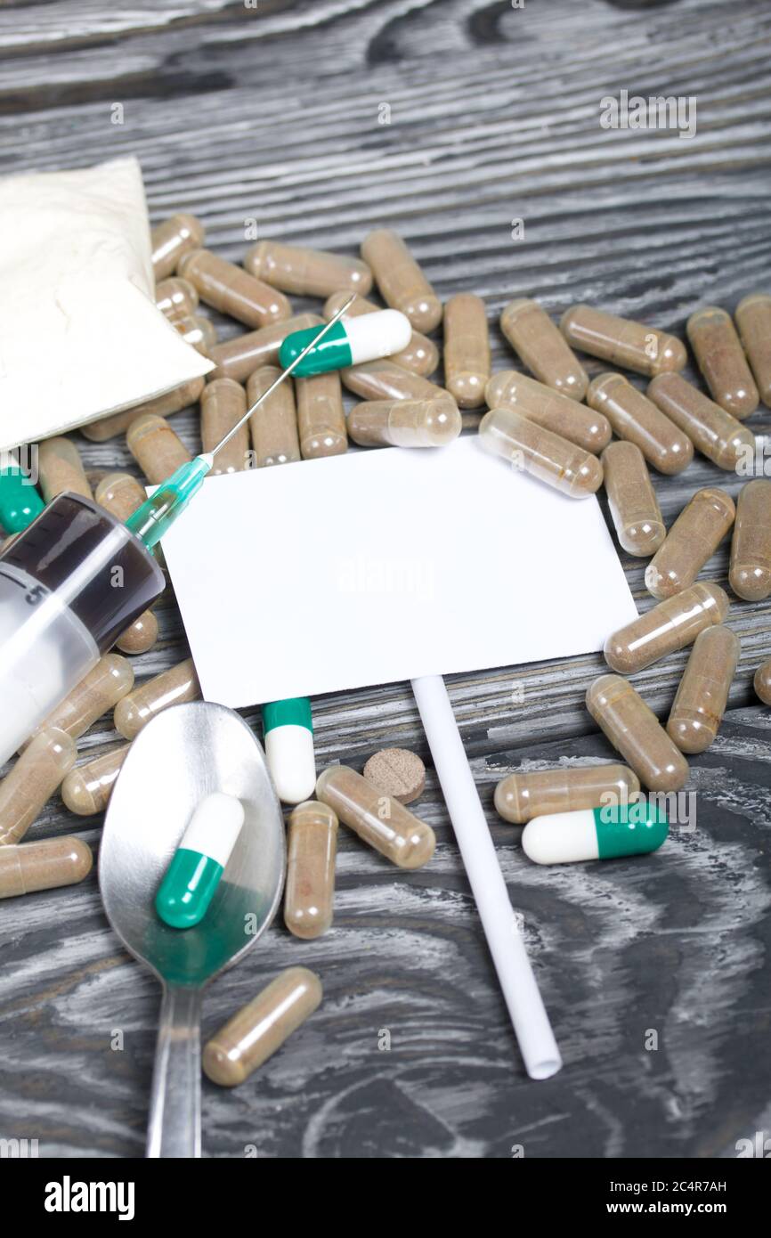 Slightly different pills on pine boards painted in black and white ...