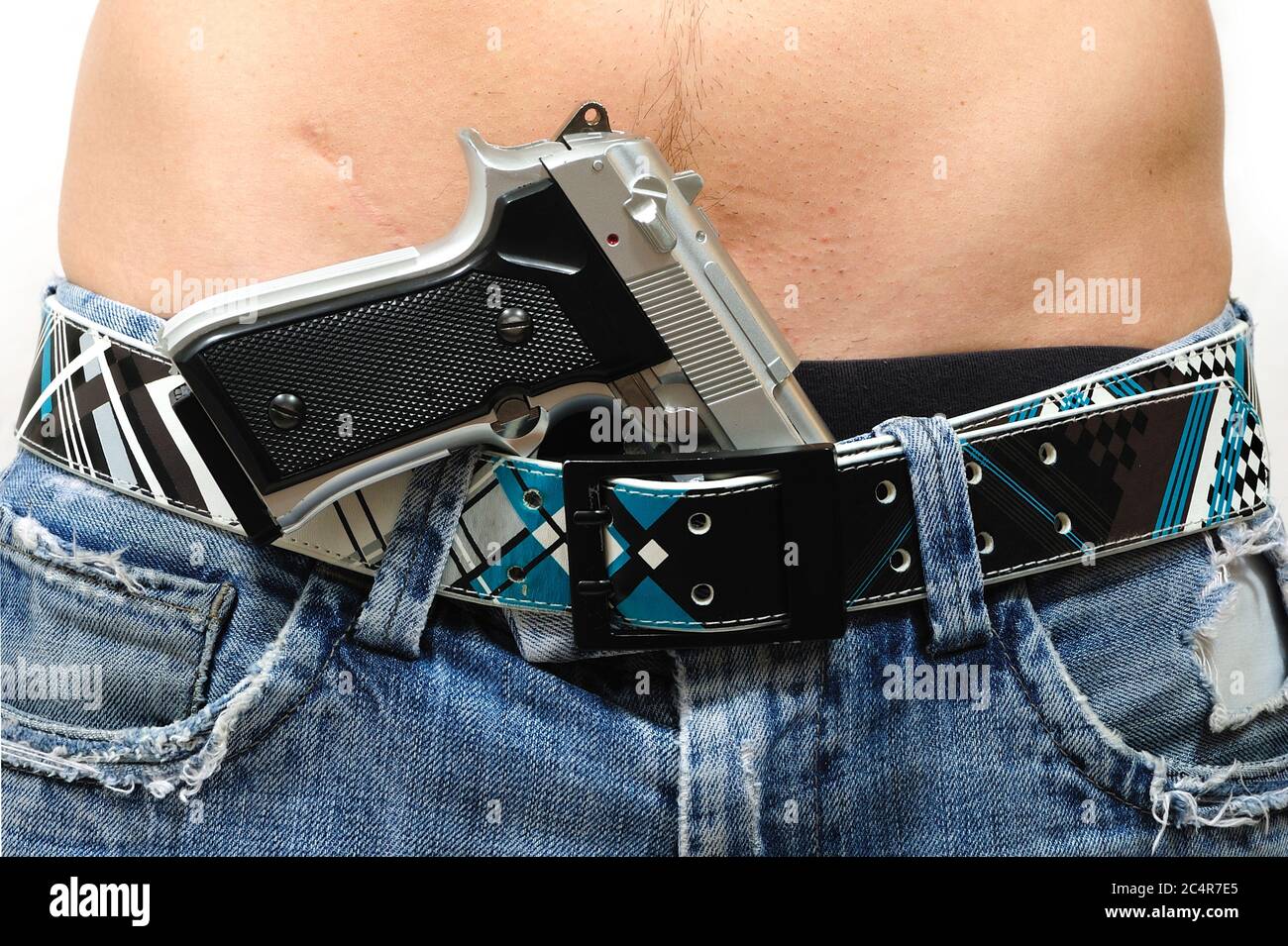 Bare-chested man with a gun tucked in his pants Stock Photo - Alamy