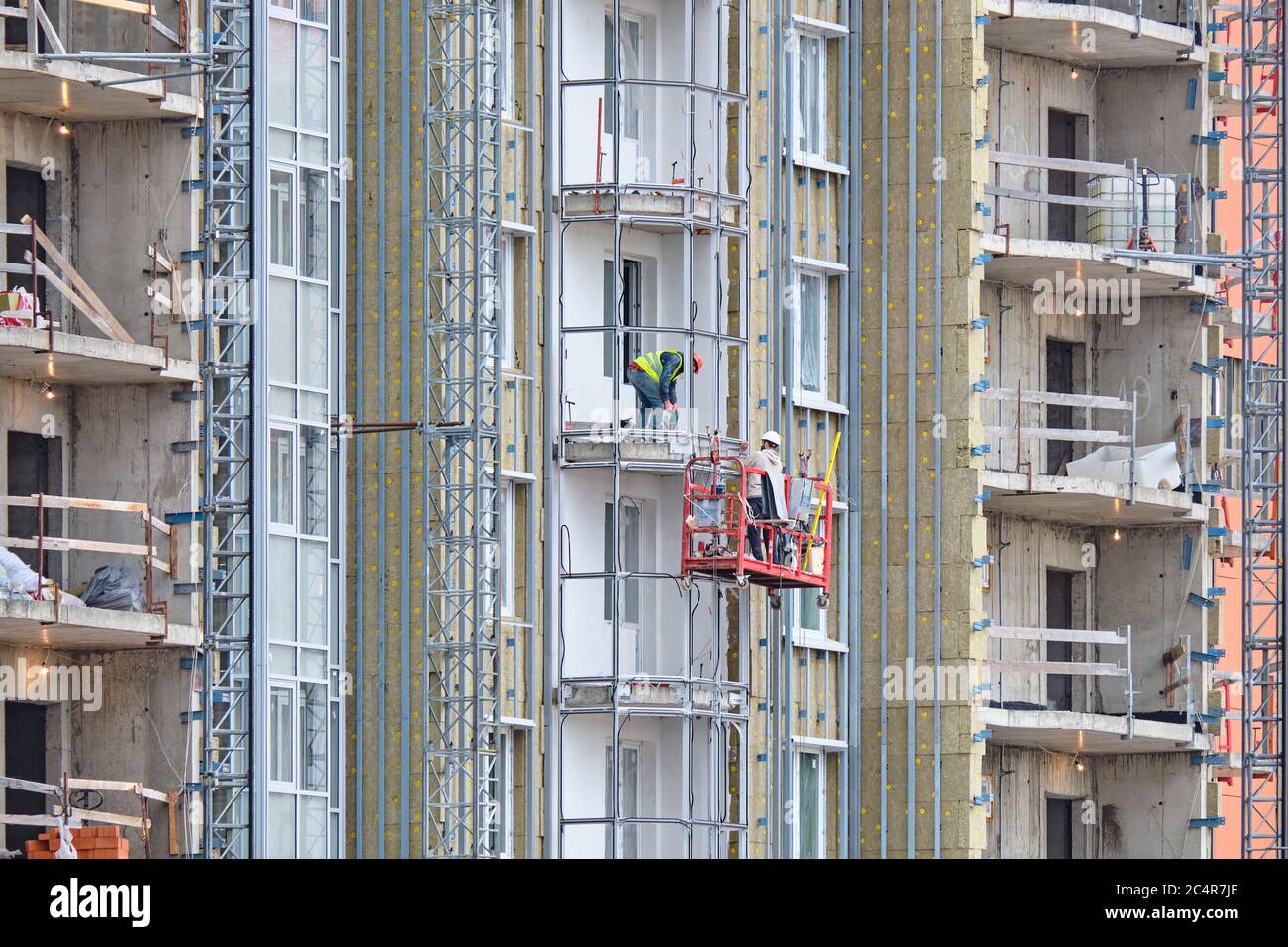 Workers build a balcony in a new modern residential building Stock ...