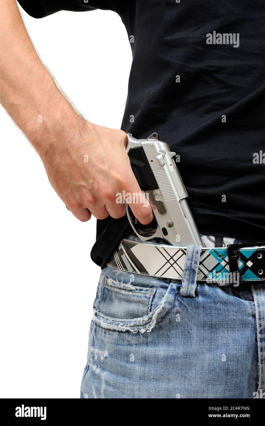 Man who pulls a gun tucked in his pants Stock Photo - Alamy