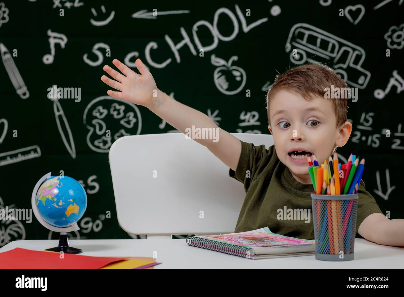 Cute child boy doing homework. Clever kid drawing at desk. Schoolboy ...