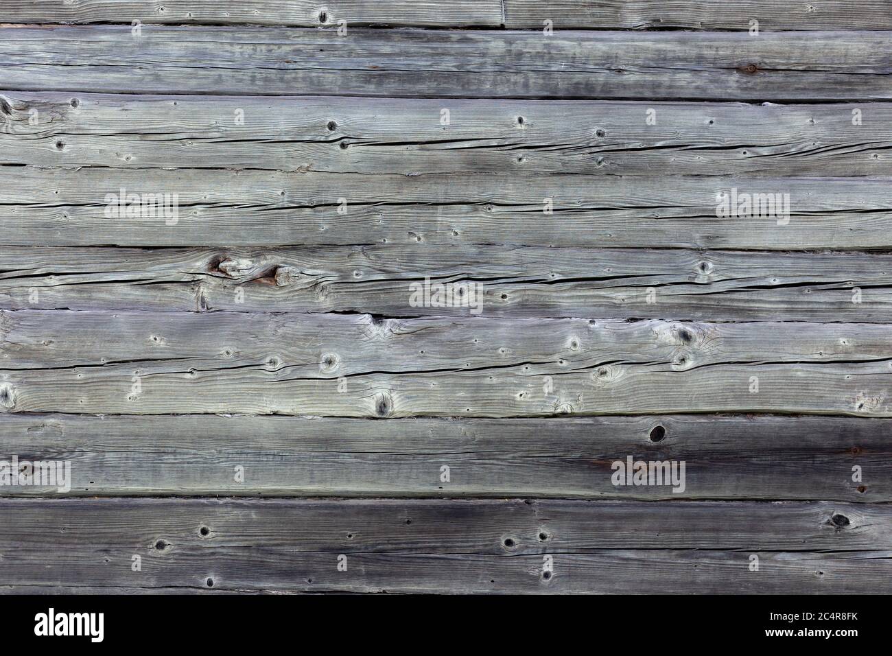 Wooden wall made of gray logs Stock Photo - Alamy