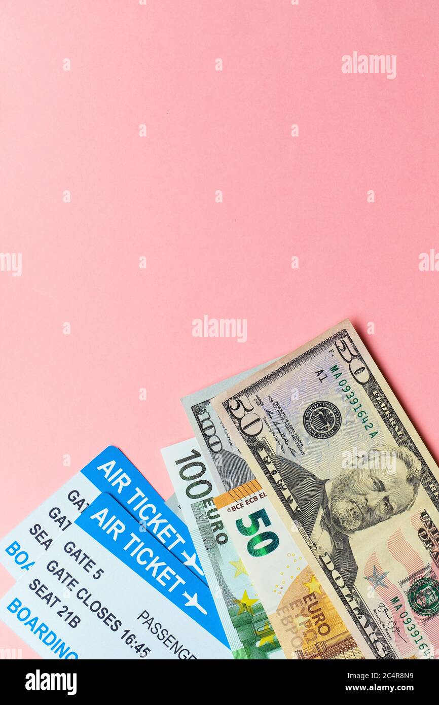 Travel concept with plane tickets and money on a pink background ...