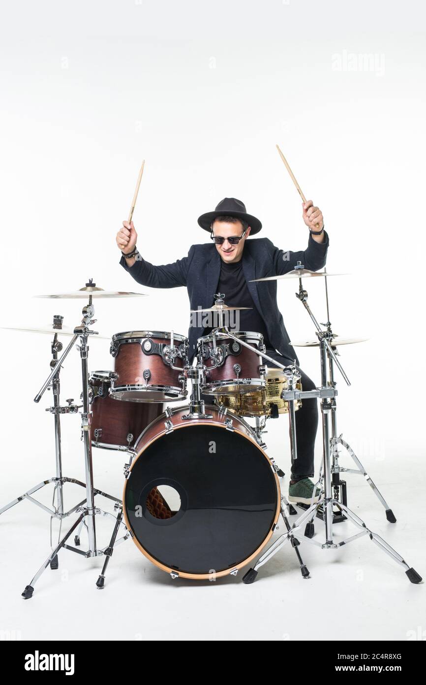 Handsome man behind the drum kit isolated on a white background Stock ...
