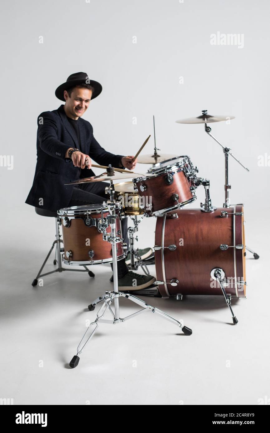 Handsome man behind the drum kit isolated on a white background Stock ...