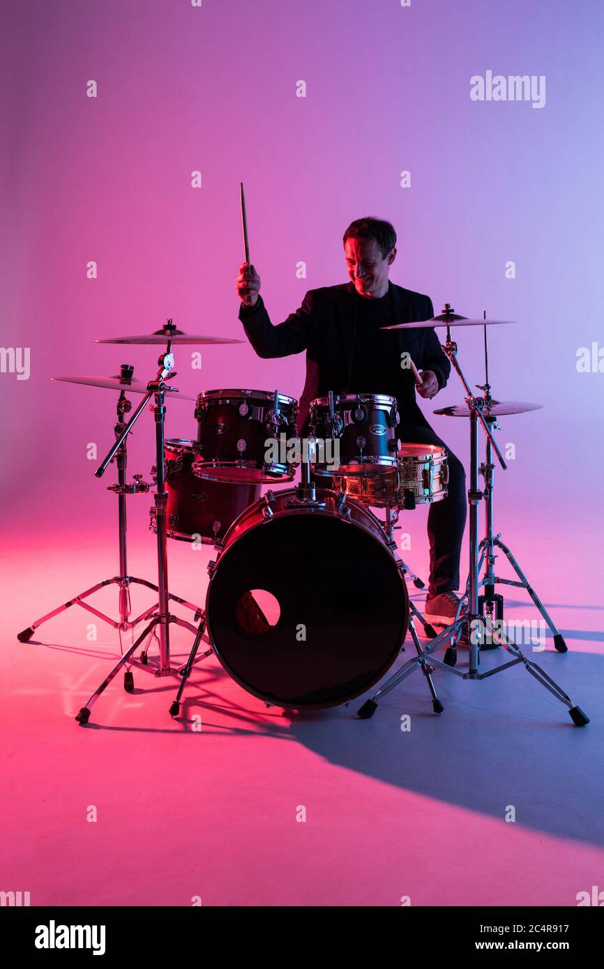 Drummer playing on drums on music concert. Club lights, artist show ...