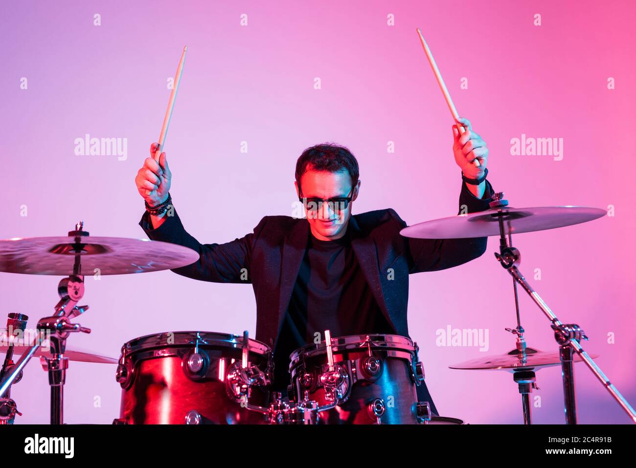 Drummer playing on drums on music concert. Club lights, artist show ...