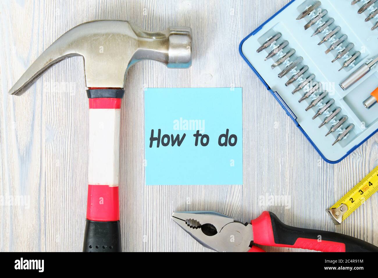 How to do concept on a sheet of paper next to work tools on wooden ...