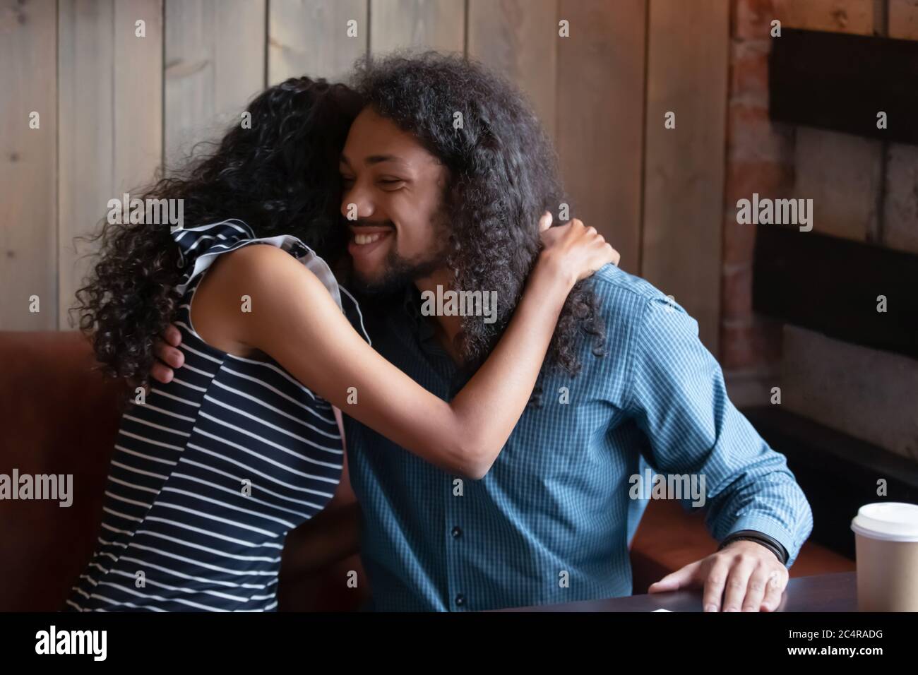 African couple hugging sit in cafe during romantic date Stock Photo - Alamy