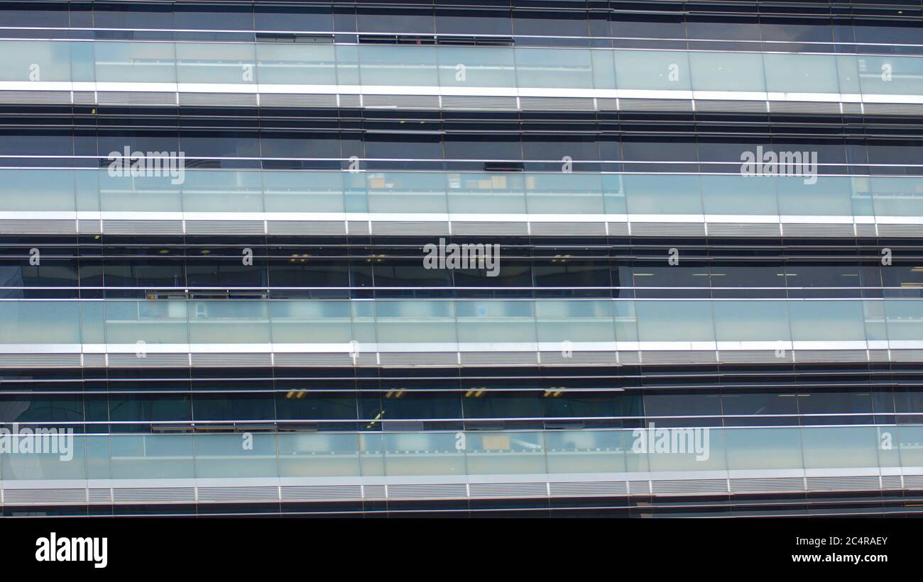 Modern building with glass windows reflected sky. Background in ...