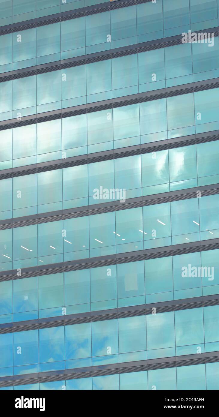 Modern building with glass windows reflected sky. Background in ...