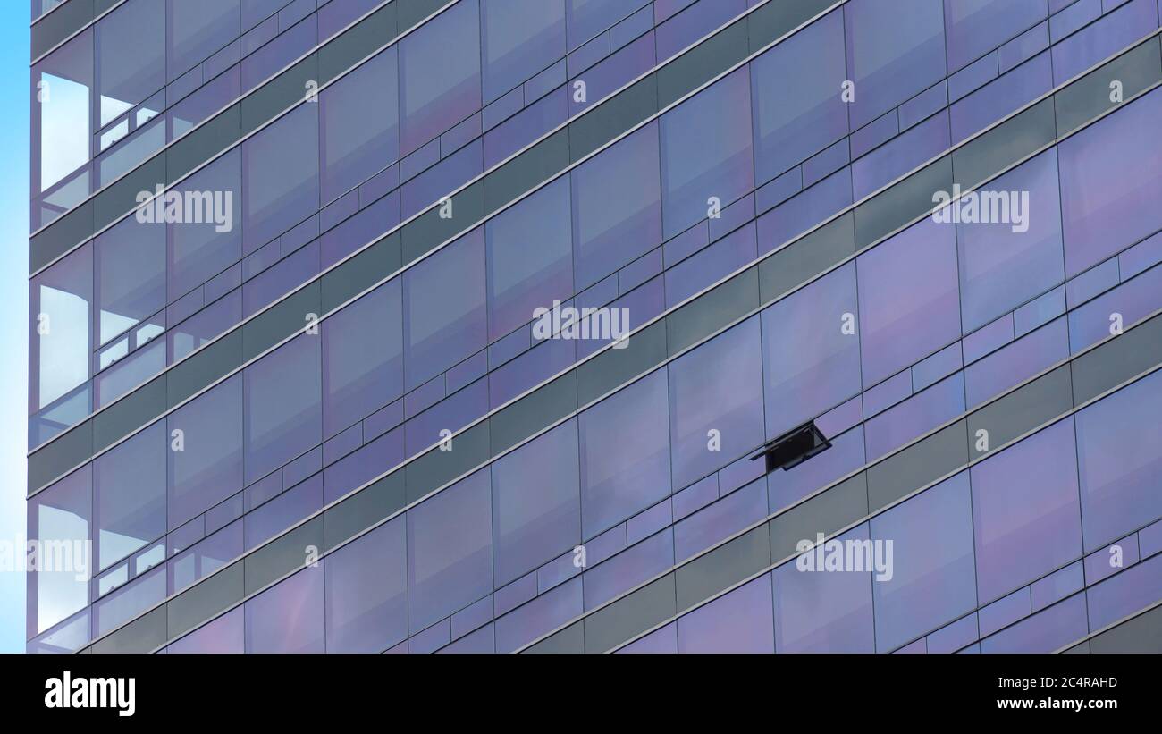 Modern building with glass windows reflected sky with open window ...