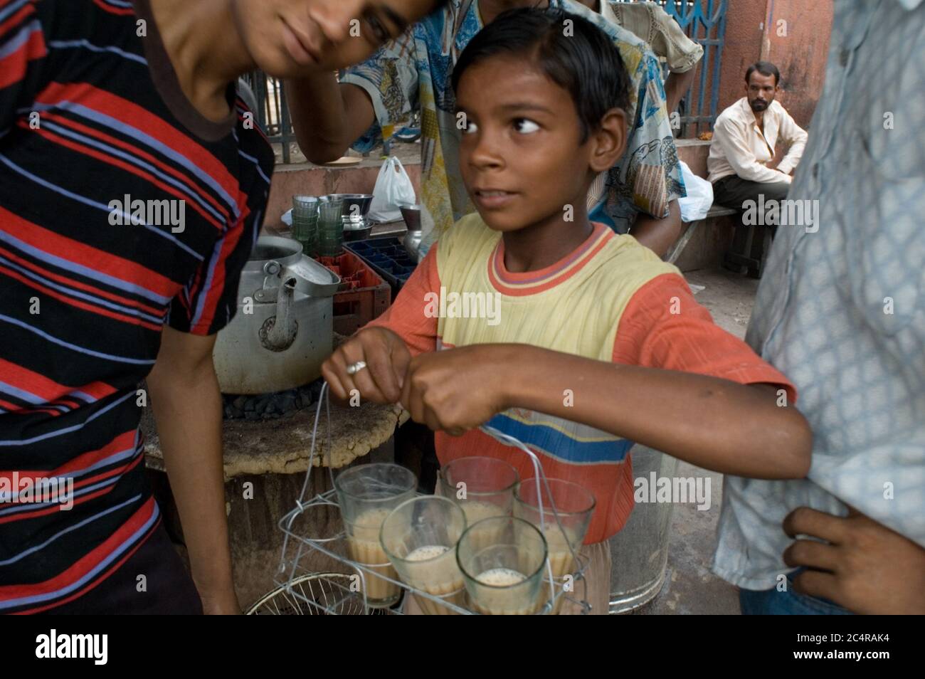 Boy who brings chai (Indian tea) to the customers around Old Delhi ...