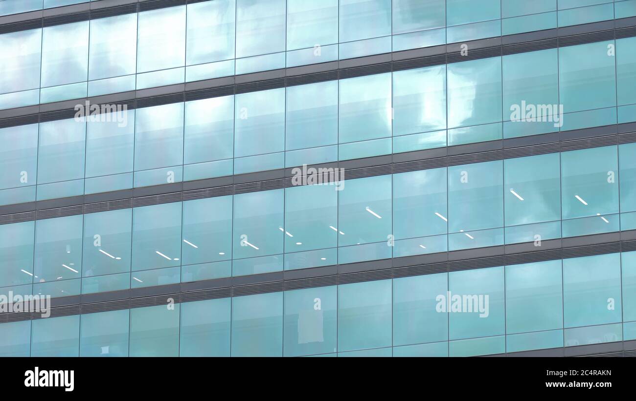 Modern building with glass windows reflected sky. Background in ...