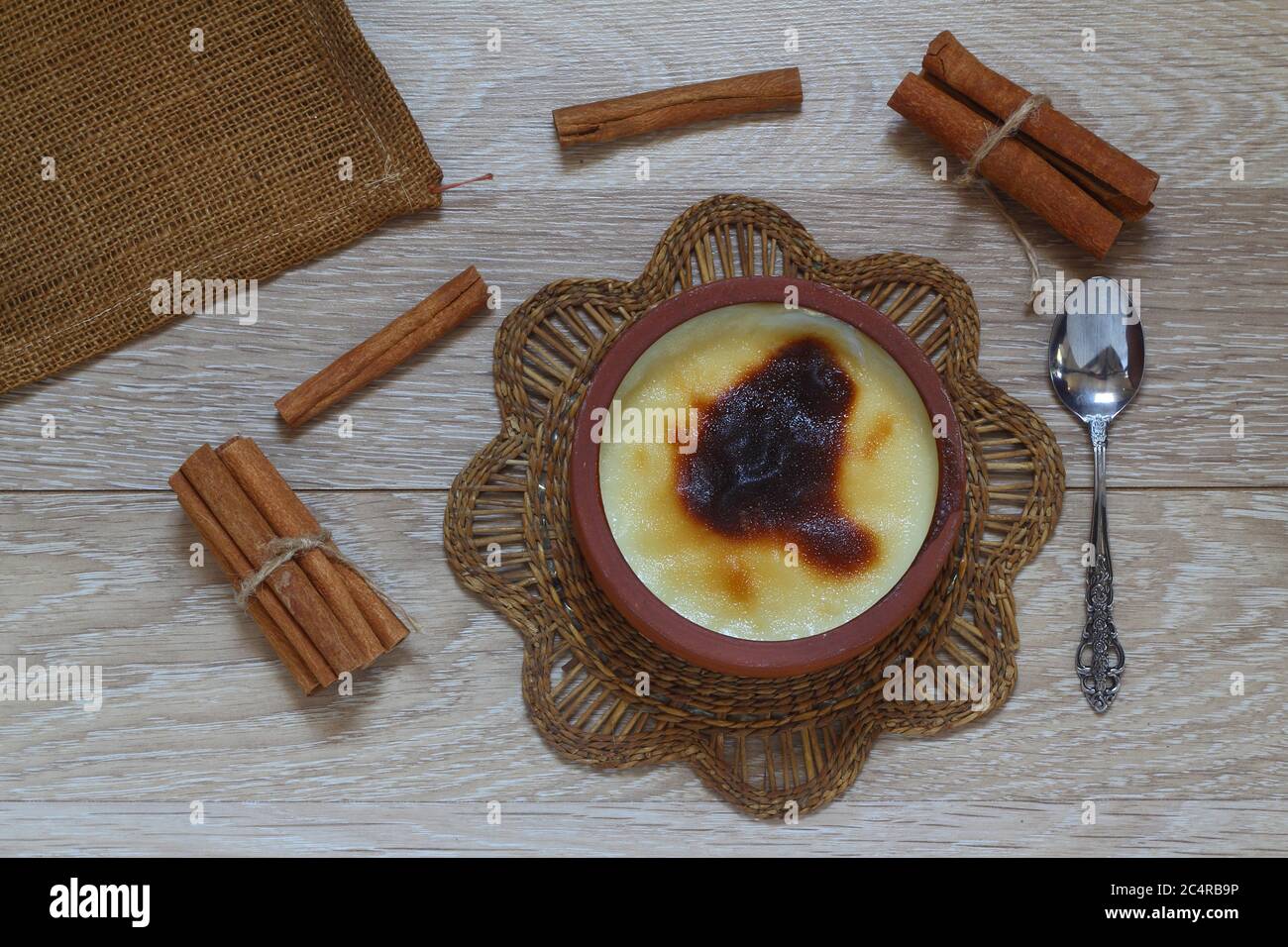 Baked rice pudding turkish dessert sutlac in earthenware casserole with ...