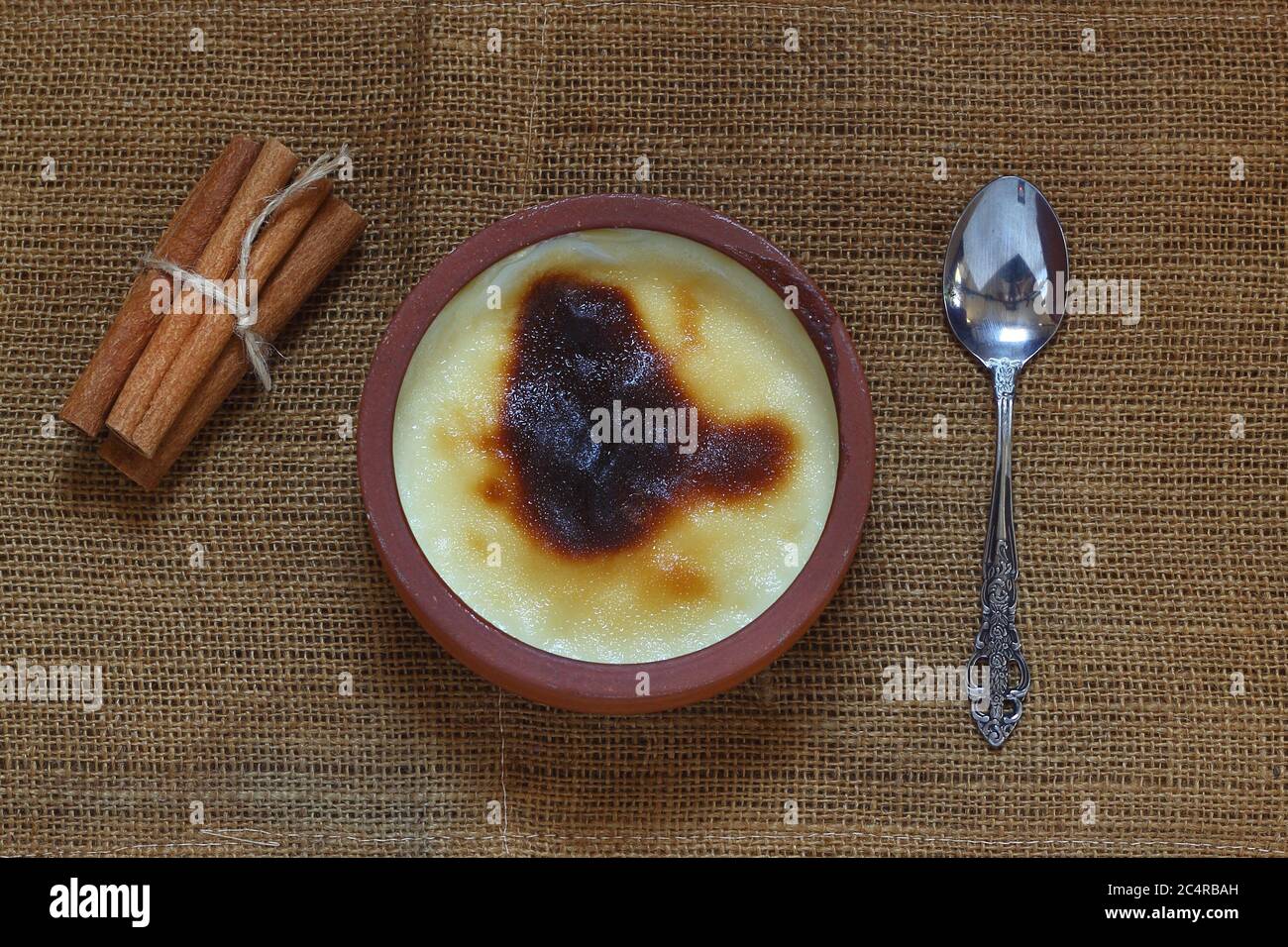 Baked rice pudding turkish dessert sutlac in earthenware casserole with ...