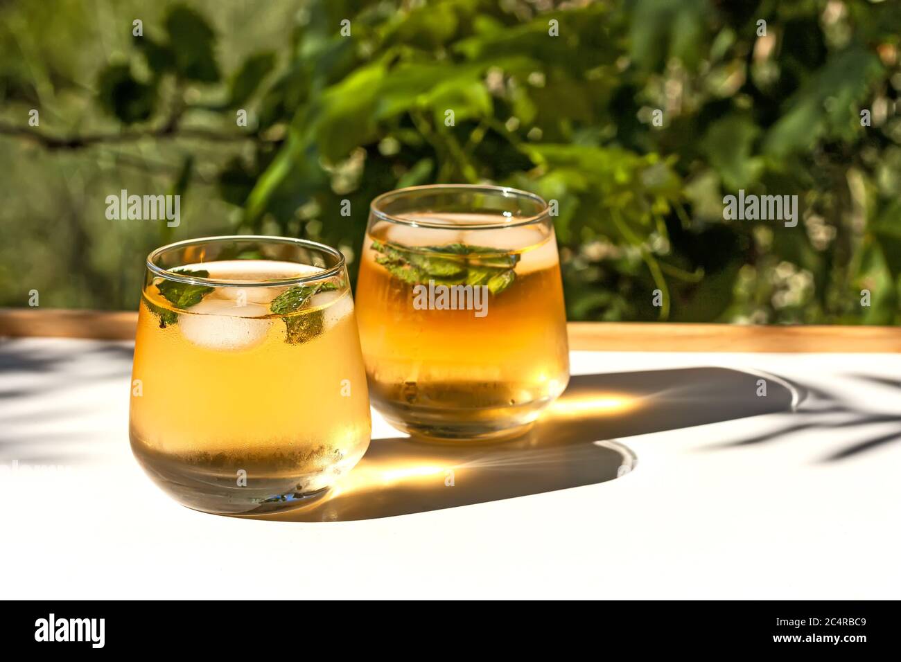 Iced summer drink. Two glasses of refreshing cold green tea with mint ...