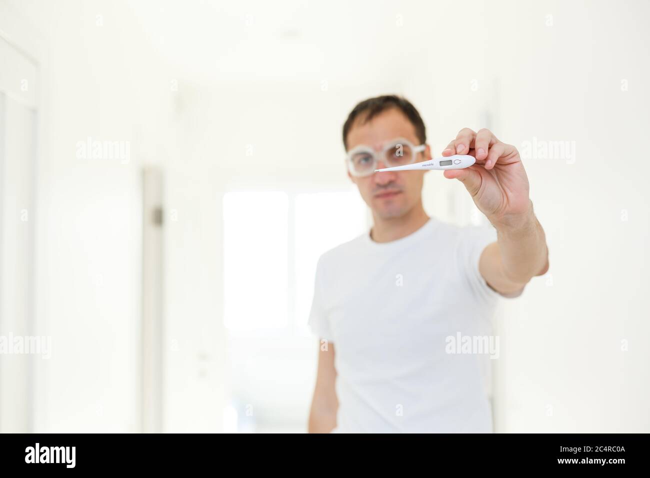 people, healthcare and fever concept, man, thermometer over grey ...