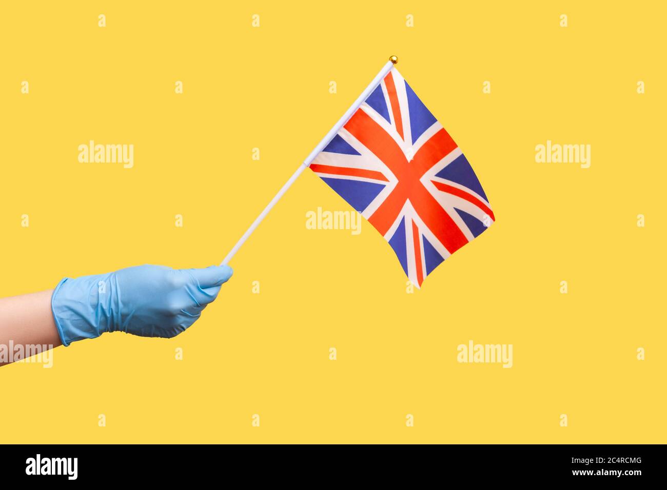 Profile side view closeup of human hand in blue surgical gloves holding ...