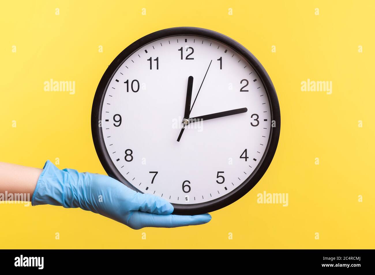 Profile side view closeup of human hand in blue surgical gloves holding ...