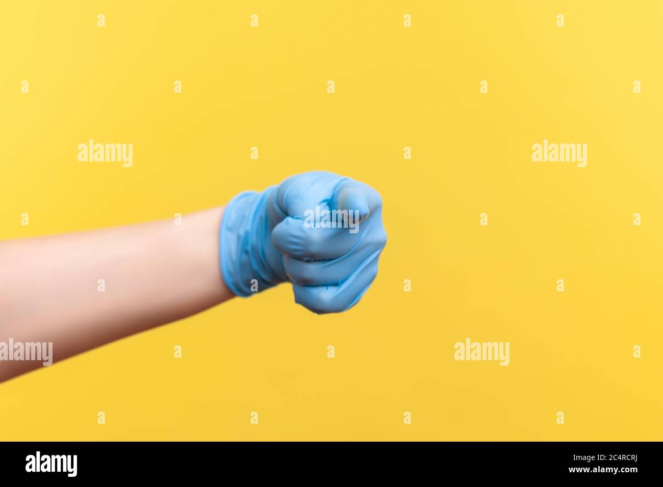 Profile side view closeup of human hand in blue surgical gloves showing ...