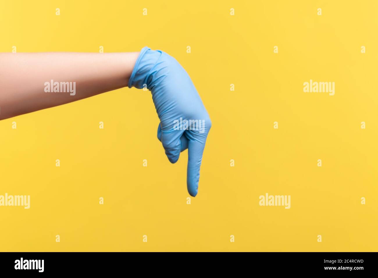 Profile side view closeup of human hand in blue surgical gloves showing ...