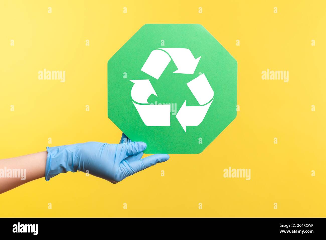 Profile side view closeup of human hand in blue surgical gloves holding ...