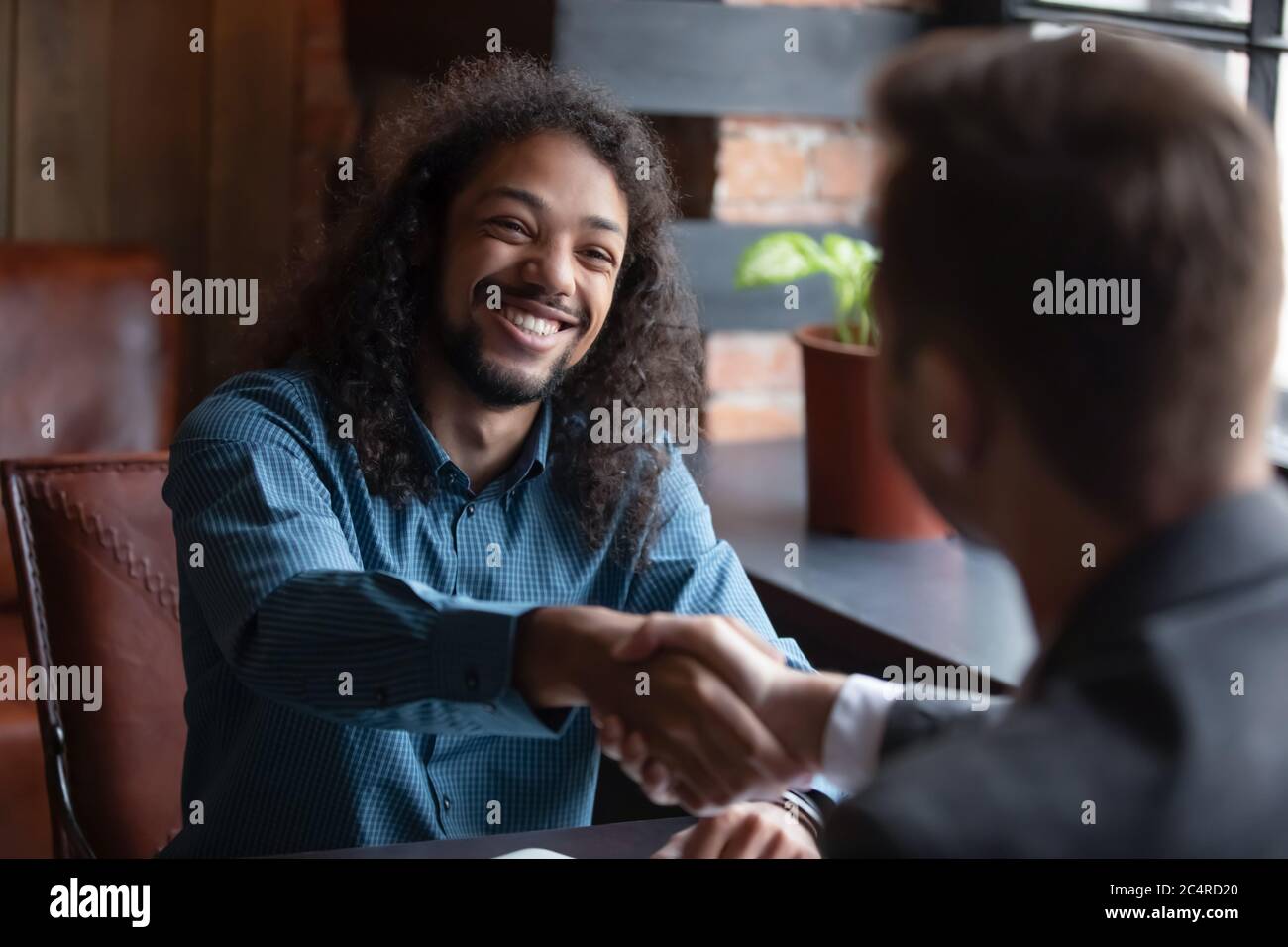 Mixed-race applicant shake hands with employer accomplish job interview ...