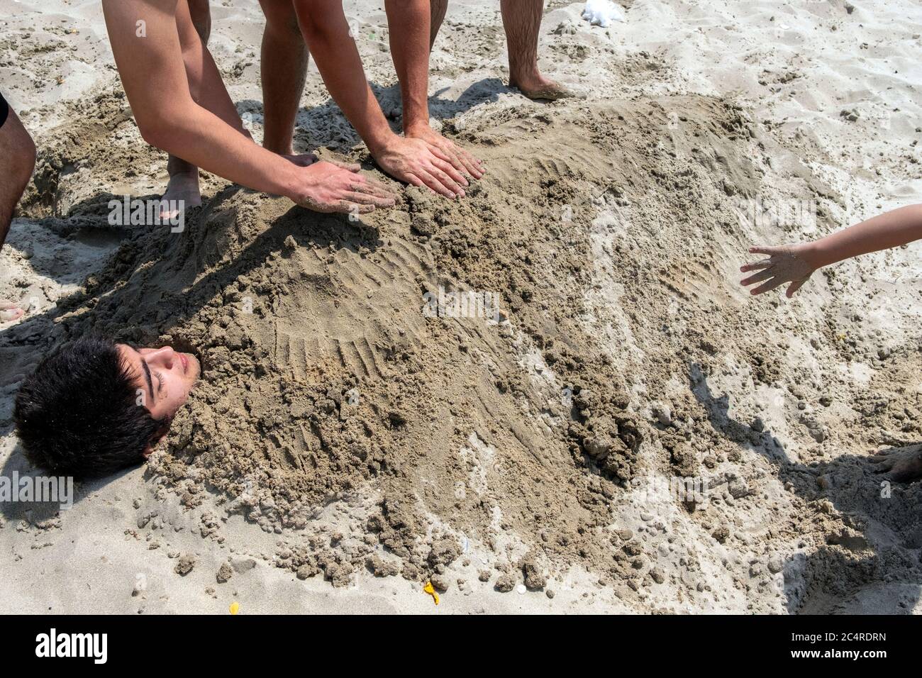 Bury in sand game hi-res stock photography and images - Alamy