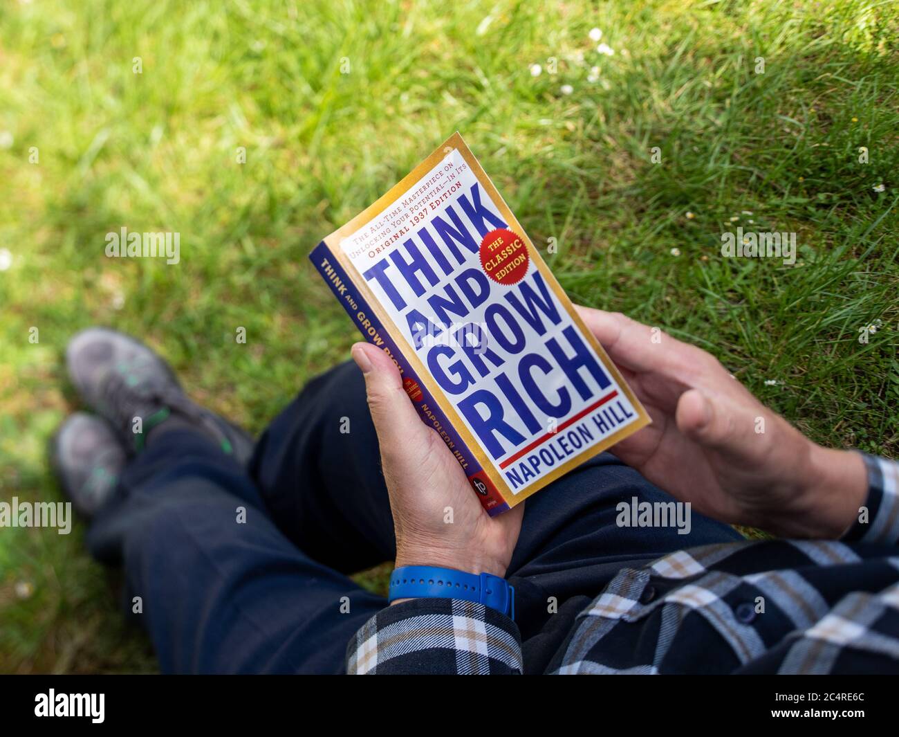 Paris, France - May 3, 2020: POV of senior curious male reading Think ...