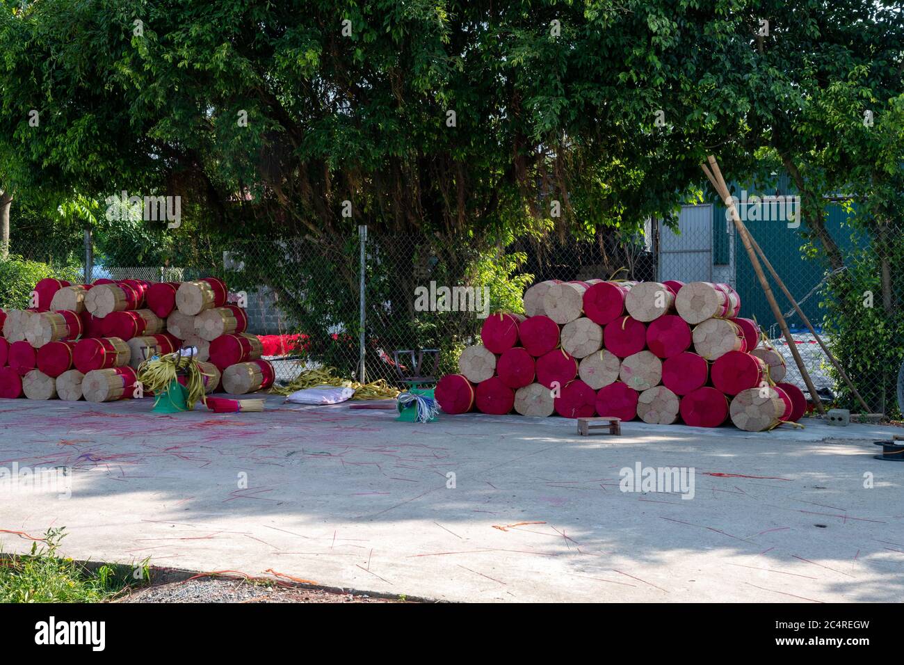 Bundles of red incense stored after drying in the sun in a field of a ...