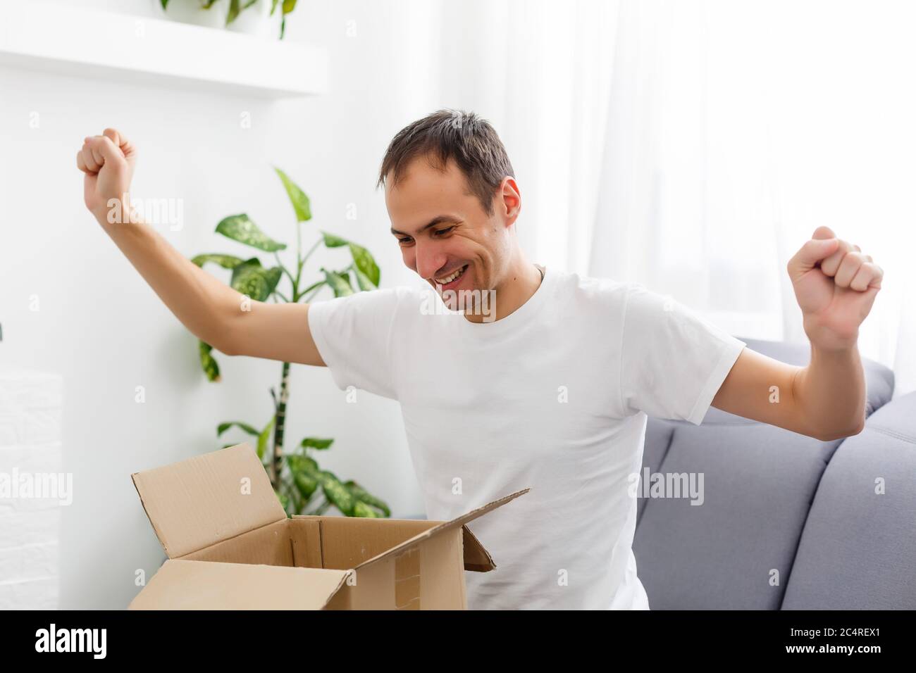 Surprised man unpacking box hi-res stock photography and images - Alamy