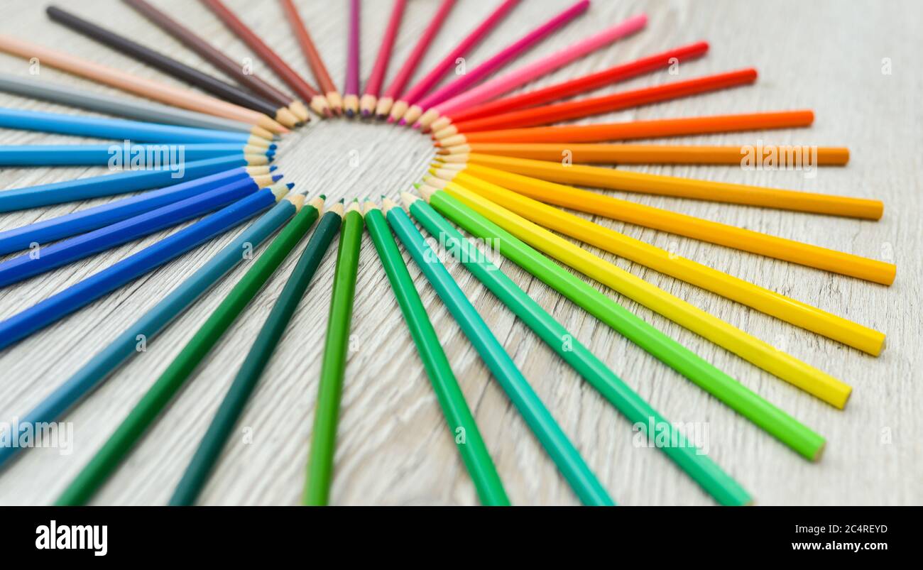 colored wooden pencils are arranged in a circle. A circular palette of ...