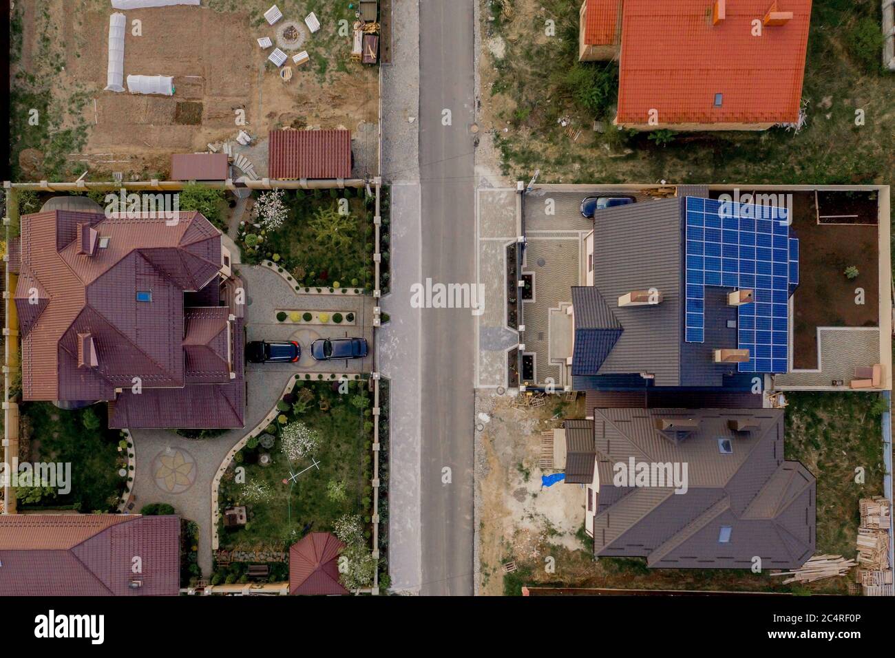 Aerial top view of a house with paved yard with green grass lawn with ...