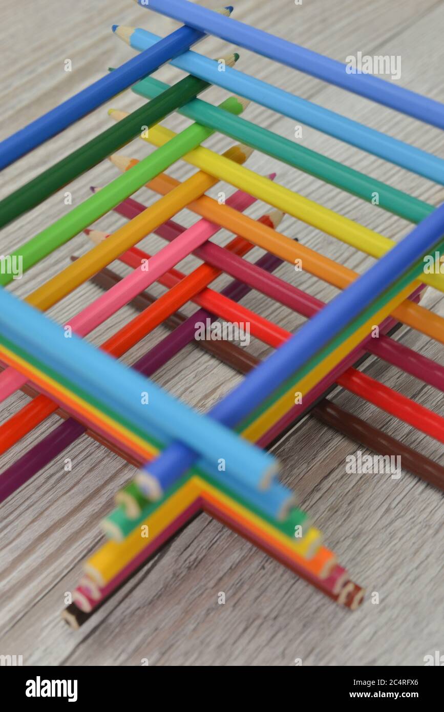 colored wooden pencils stacked in a pyramid. Colored pencils palette ...