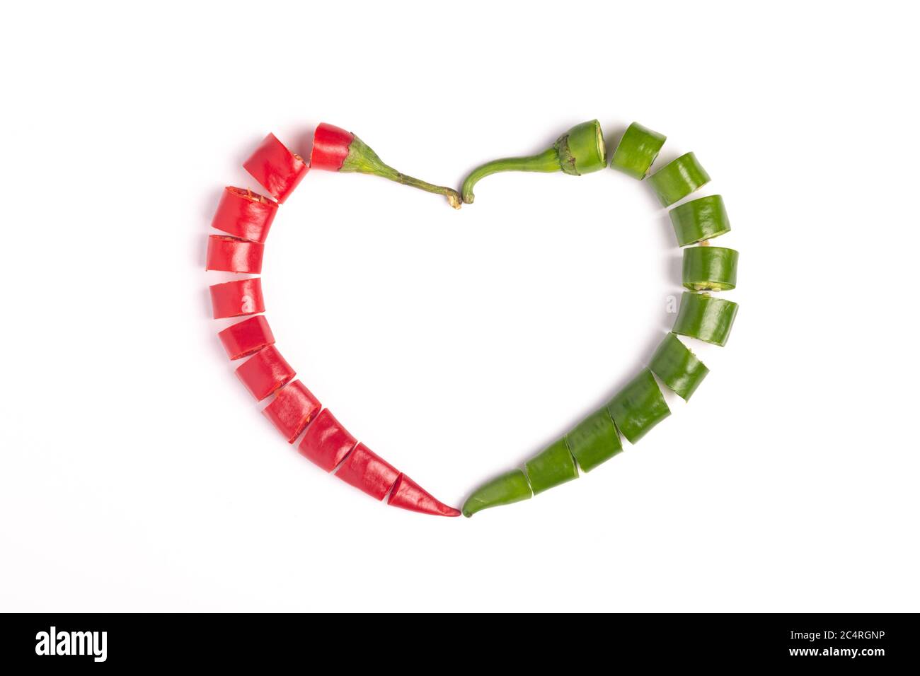 Red and green chilli pieces arranged together to show to love and ...