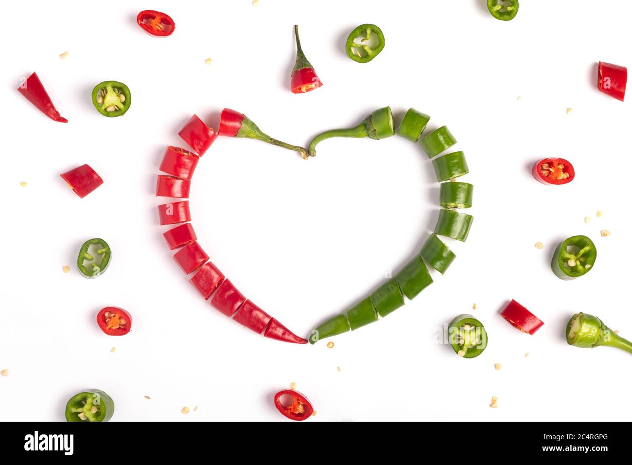 Red and green chilli pieces arranged together to show to love and ...