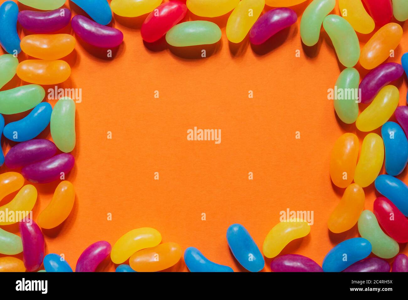 Assorted Jelly Beans border with copyspace on orange background Stock ...